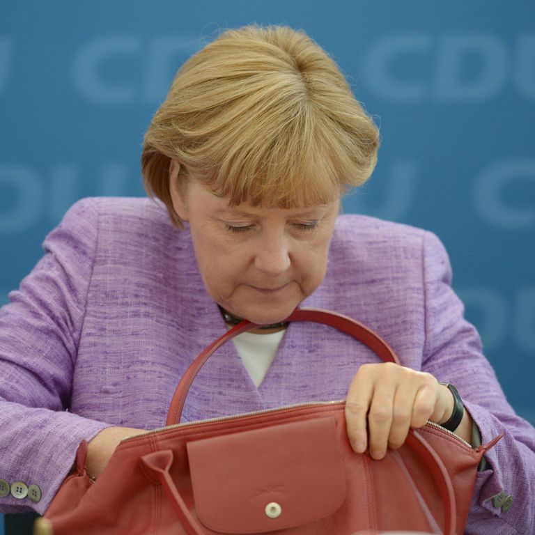 Angela Merkel Loves Rummaging Through Her Enormous Handbag