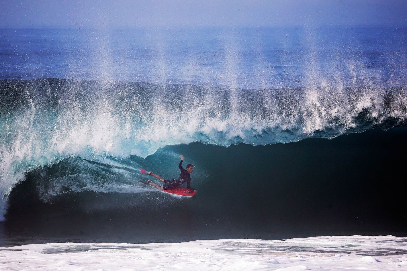 Surfers Tackle 20-Foot Waves While You Sit Inside Reading This