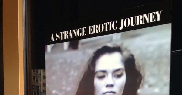 Man Plasters Posters for Rochelle Rochelle on Upper East Side Movie Theater