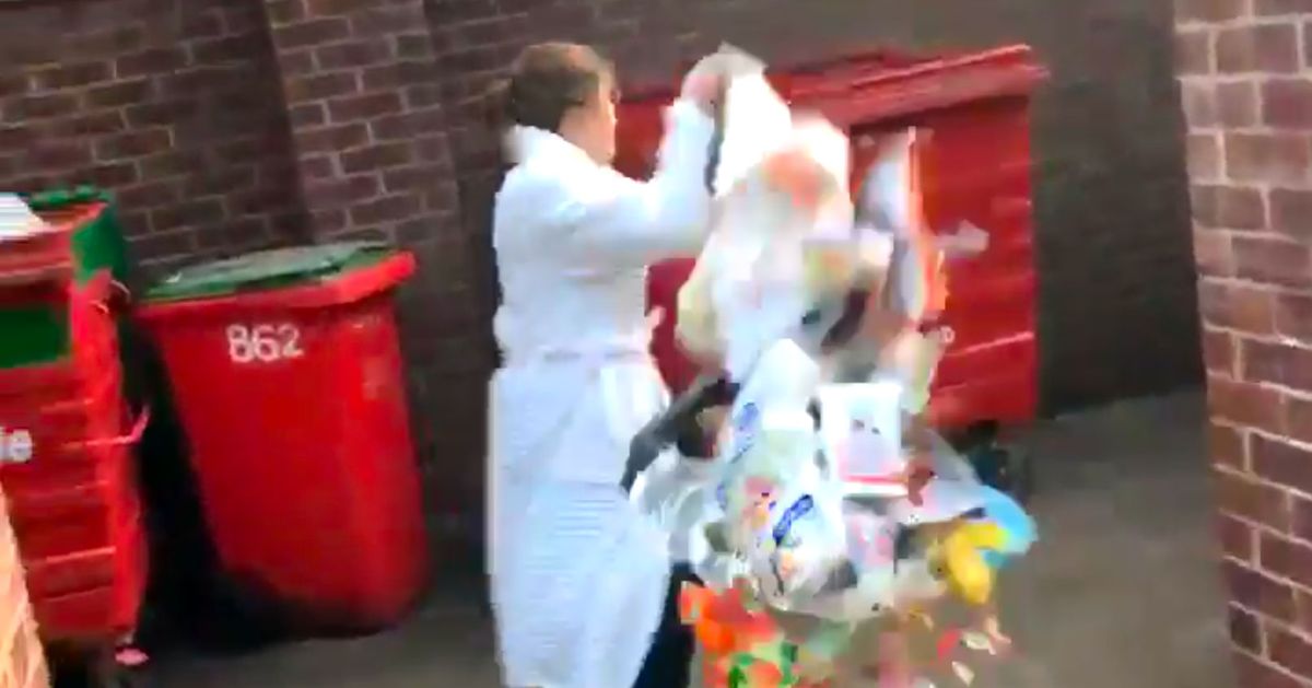 Bathrobe Woman Tries and Fails to Throw Trash in Dumpster