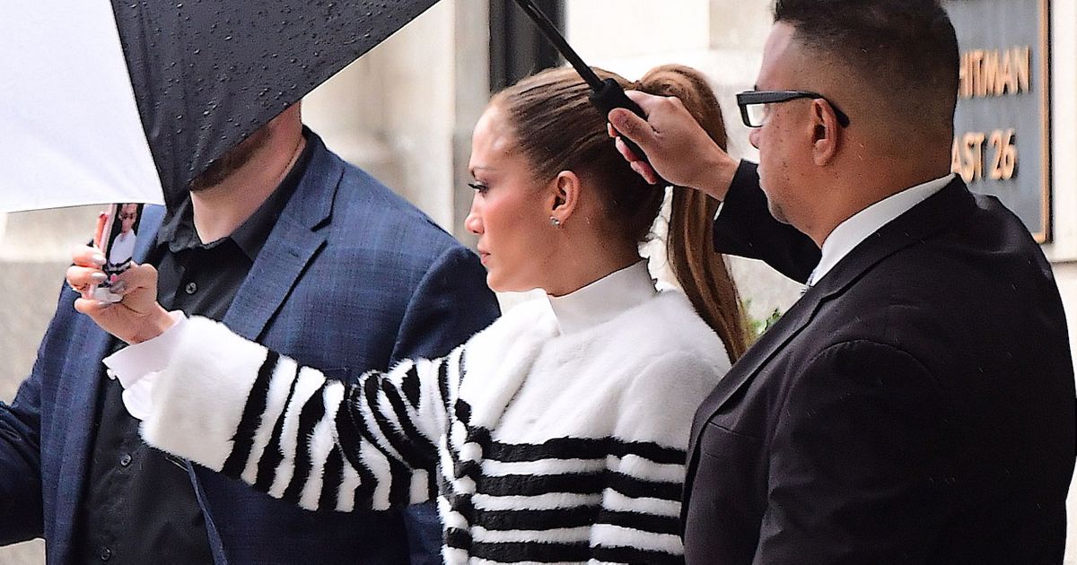 Jennifer Lopez Takes Selfie in Rain With Two Umbrella Guys
