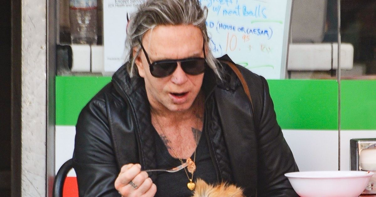 Mickey Rourke Feeds Pomeranian Dog in a High Chair