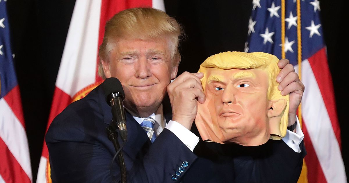 Donald Trump Holds Trump Mask Onstage at Florida Rally