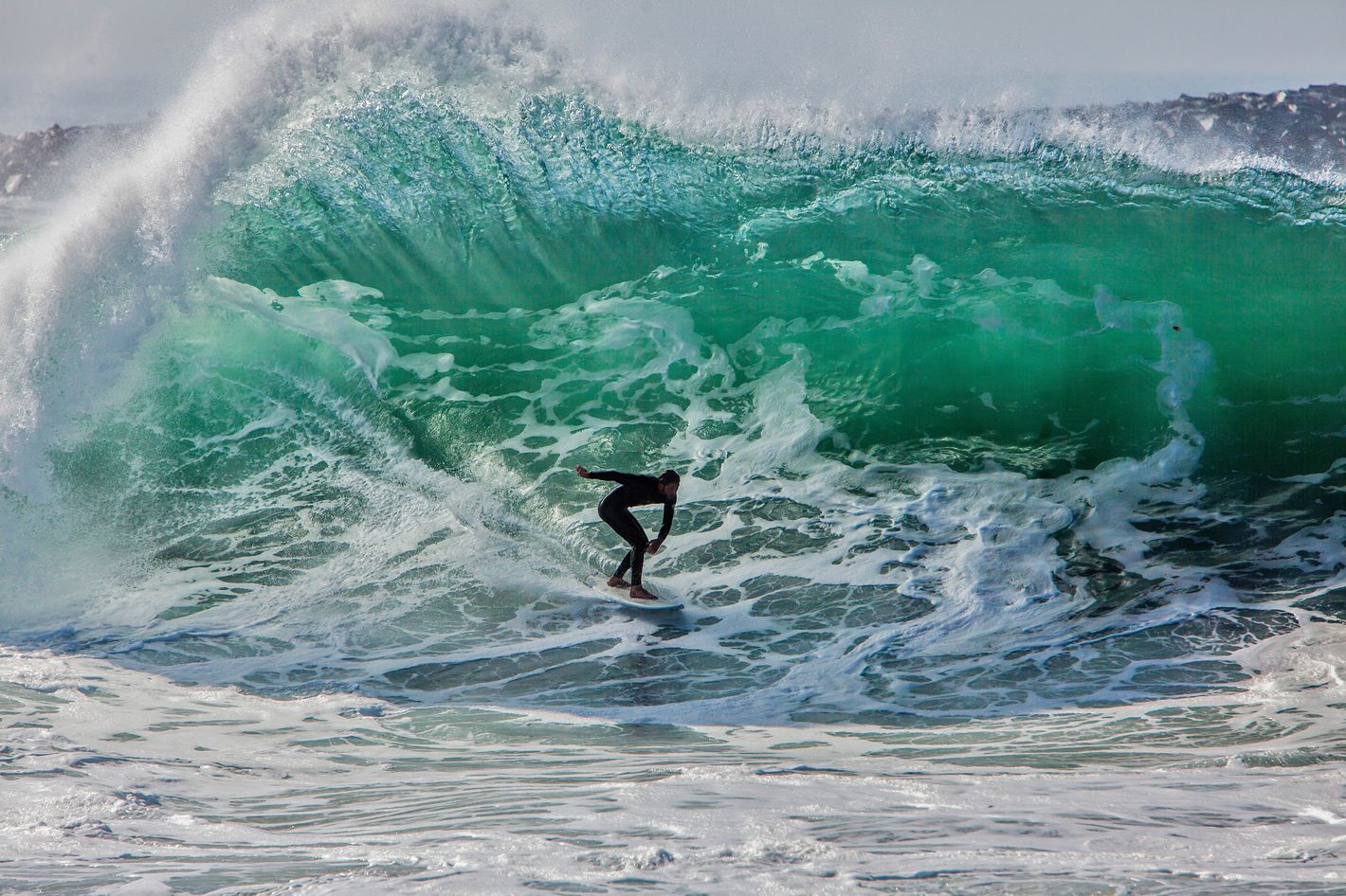Surfers Tackle 20-Foot Waves While You Sit Inside Reading This