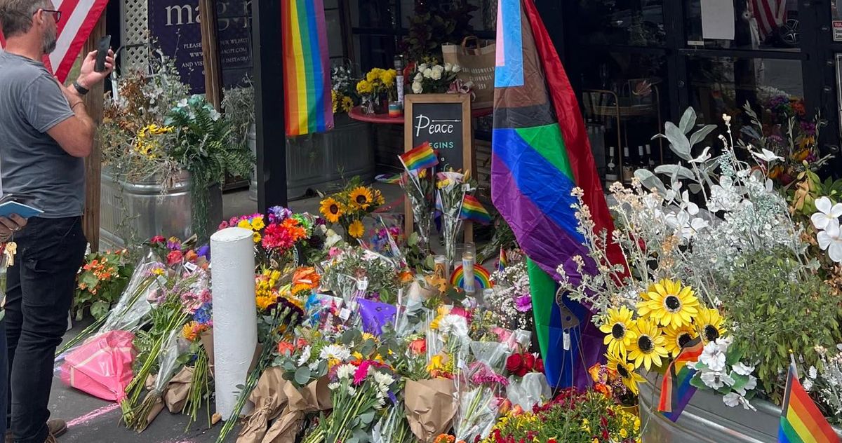 Laura Ann Carleton Shot for Hanging Pride Flag Outside Store