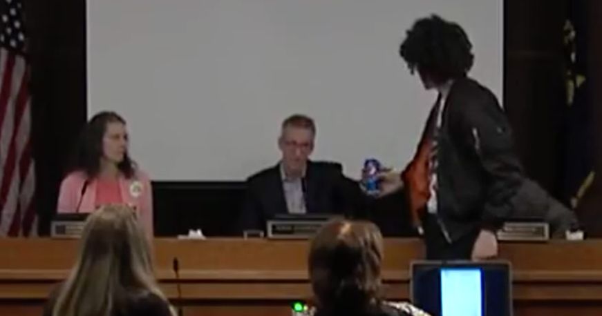 Activist Gives Pepsi Can to Mayor at City Council Meeting